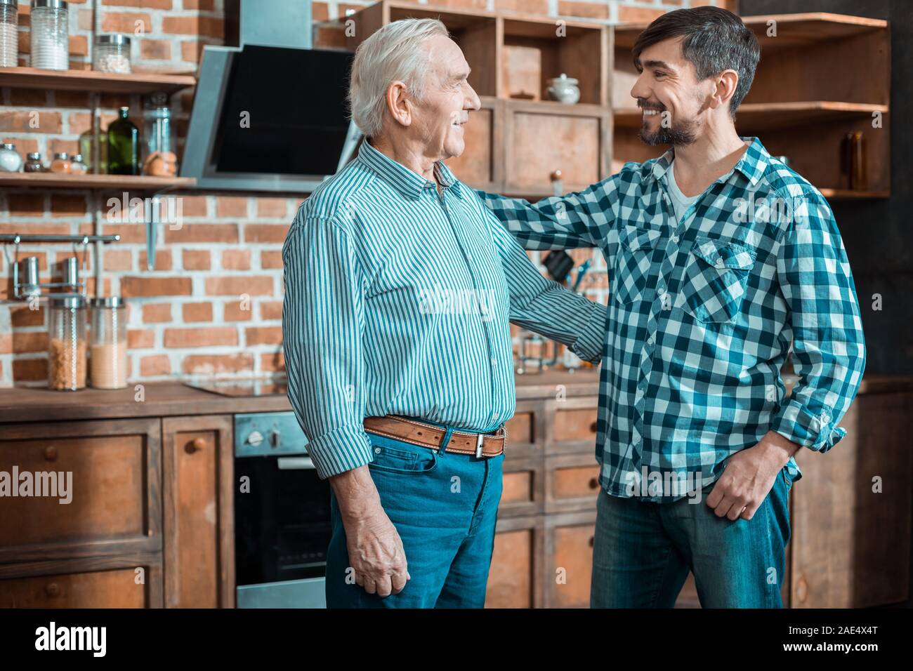 Joyful positive man hugging his father Stock Photo - Alamy Joyful positive man hugging his father Stock Photo - Alamy