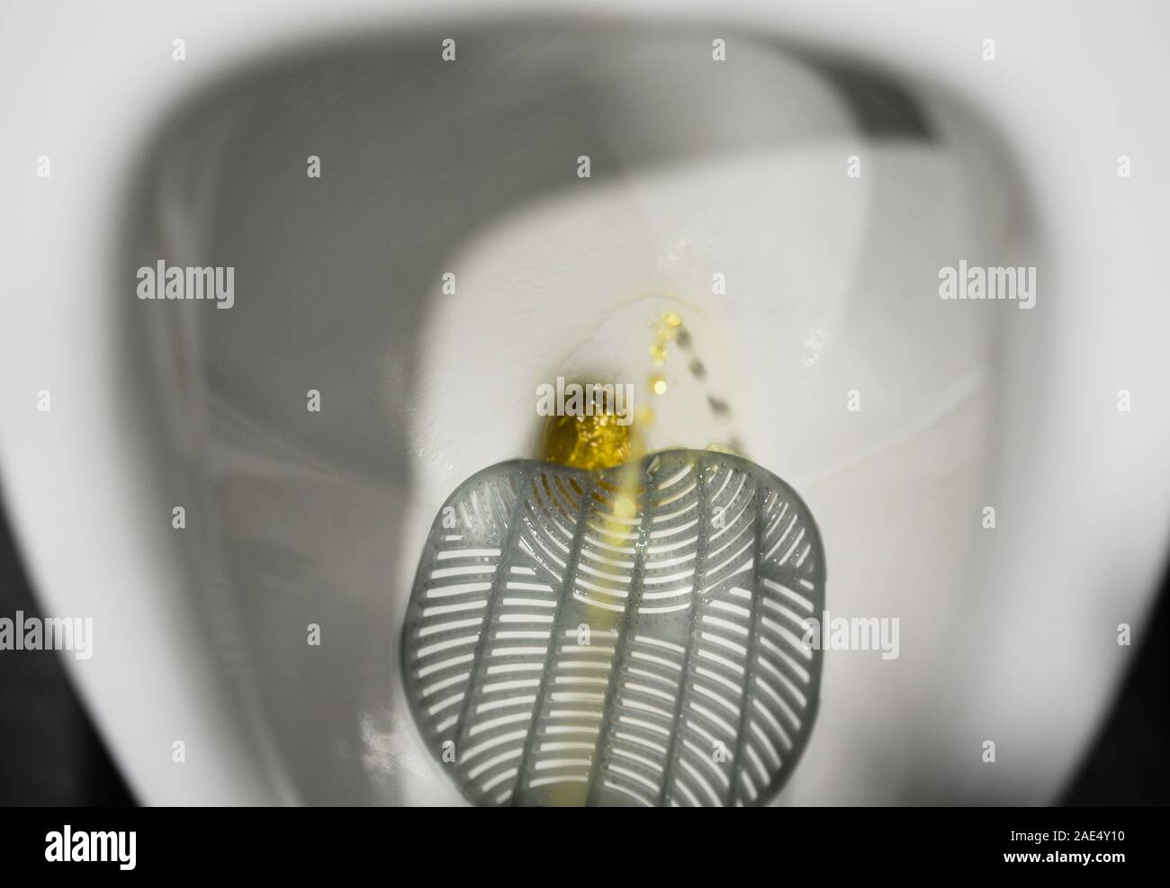 Peeing urinating urine in urinal pissoir toilet facility Stock Photo ...