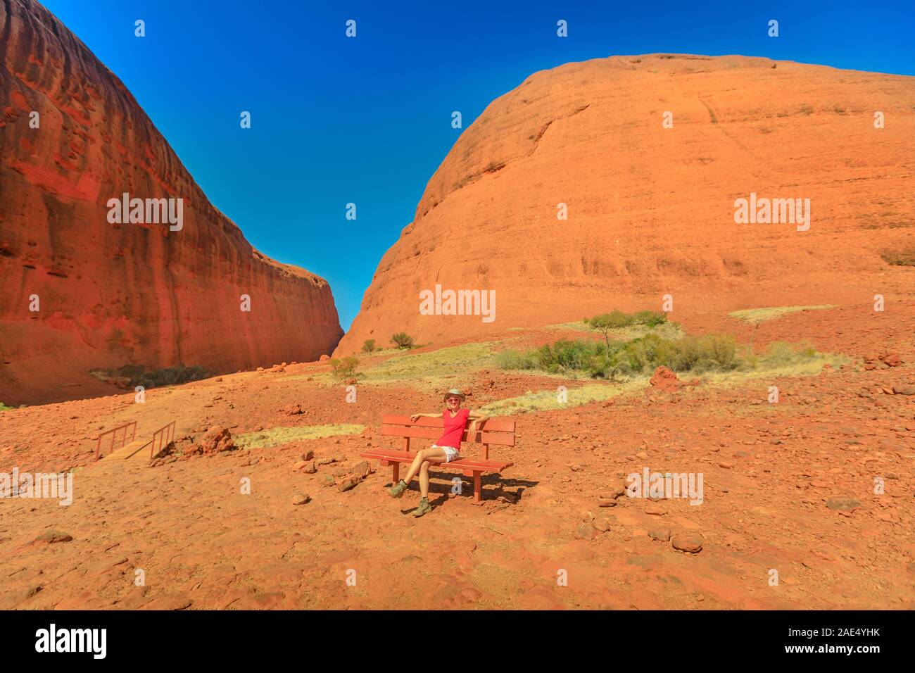 Tourist woman sitting on a bench at entrance of the gorge along Walpa ...