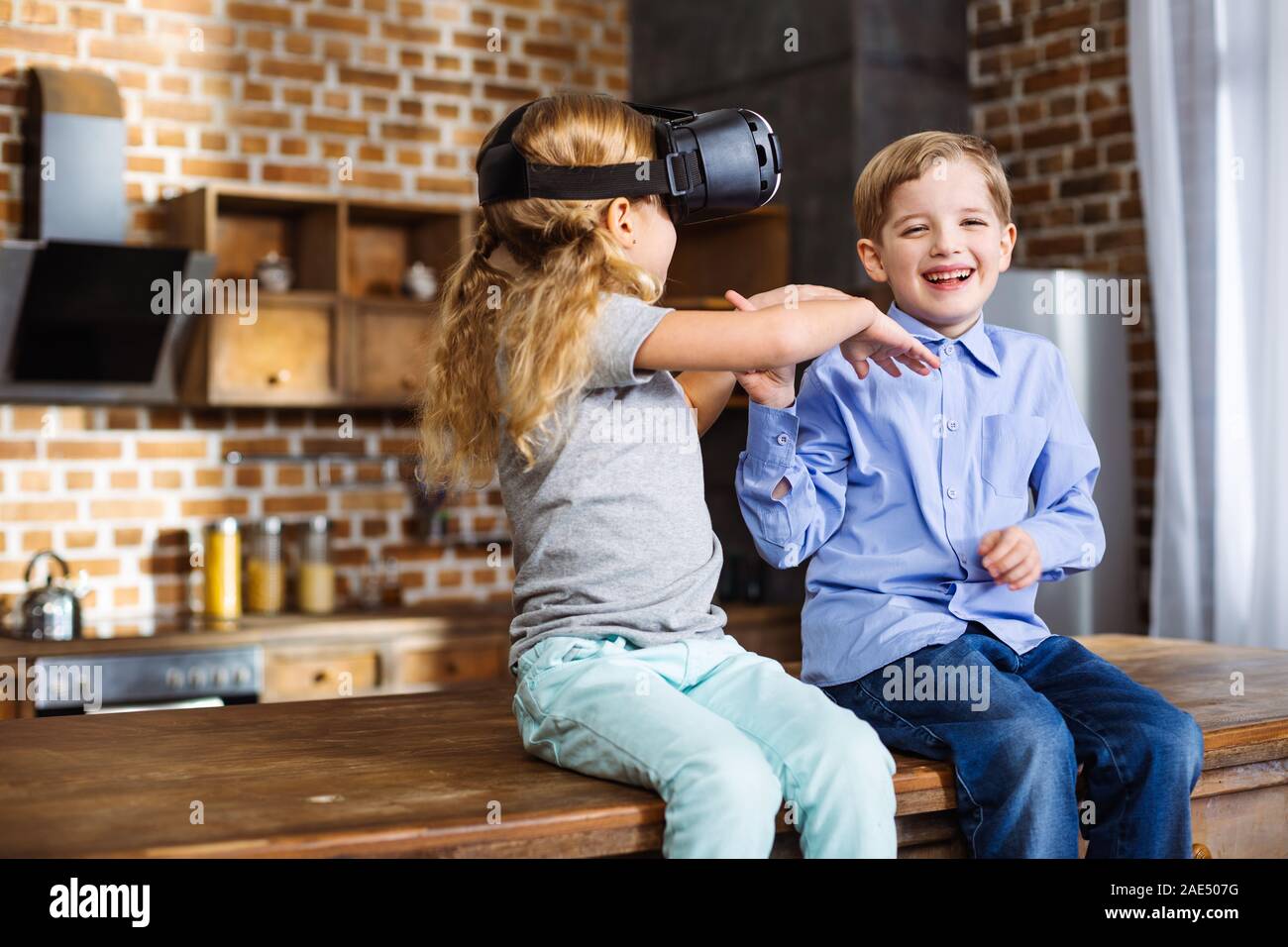 Positive little girl wearing VR glasses Stock Photo - Alamy Positive little girl wearing VR glasses Stock Photo - Alamy
