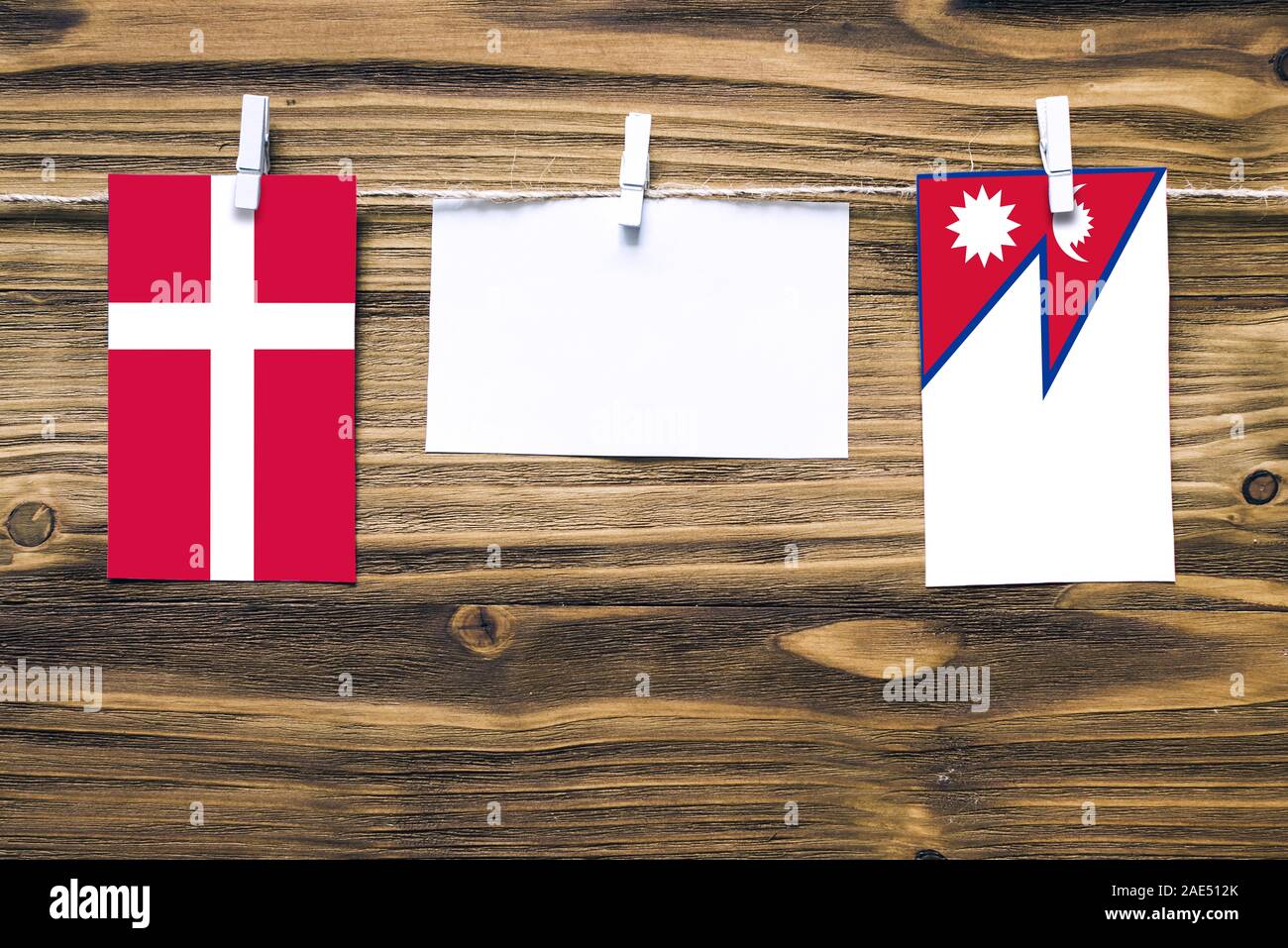 Hanging flags of Denmark and Nepal attached to rope with clothes pins ...