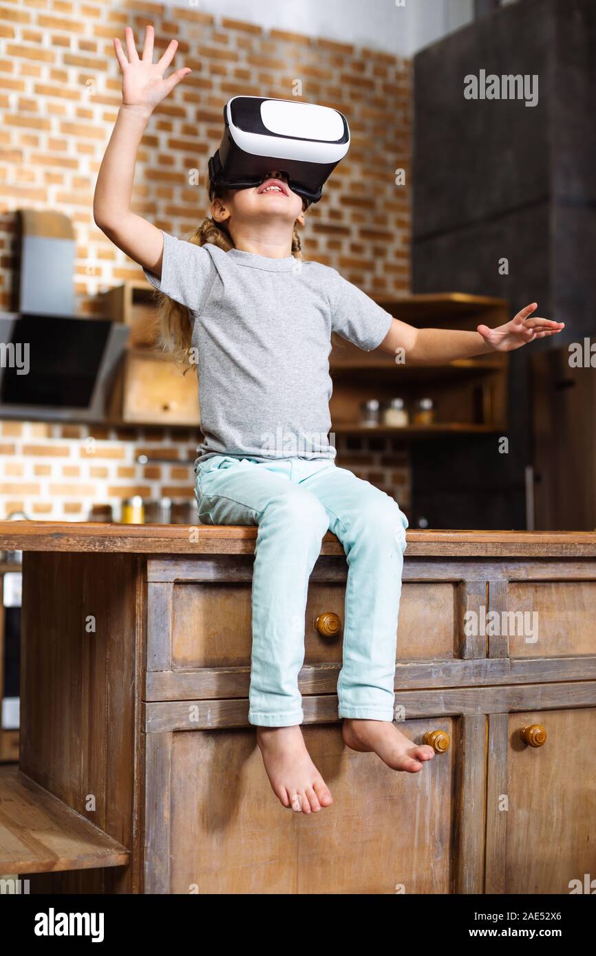 Cheerful little girl testing VR glasses Stock Photo - Alamy Cheerful little girl testing VR glasses Stock Photo - Alamy