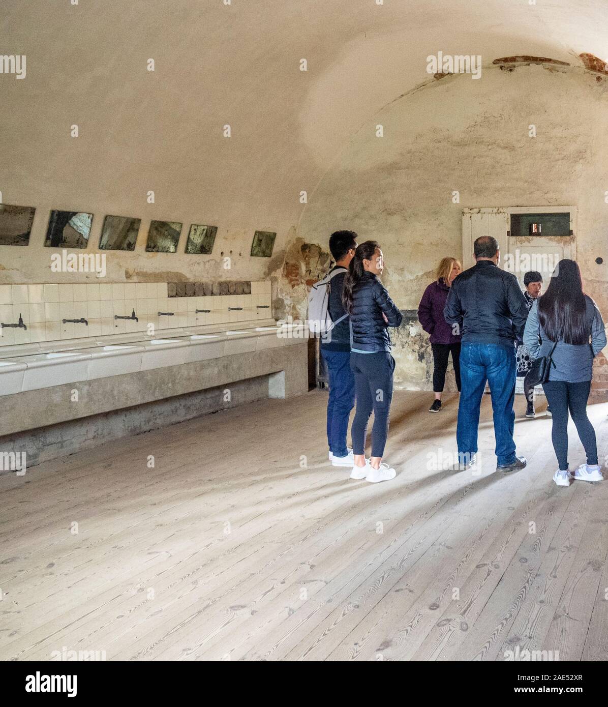 Tourist in guided tour of Theresienstadt Malá pevnost small fortress Nazi concentration camp ...