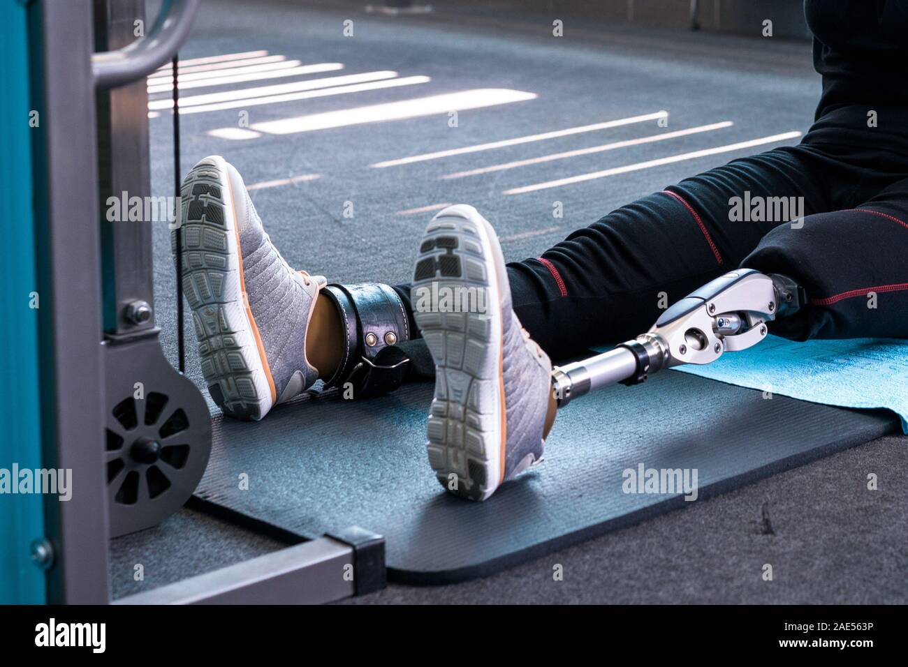 Personal trainer assisting woman with disabilities in her workout ...