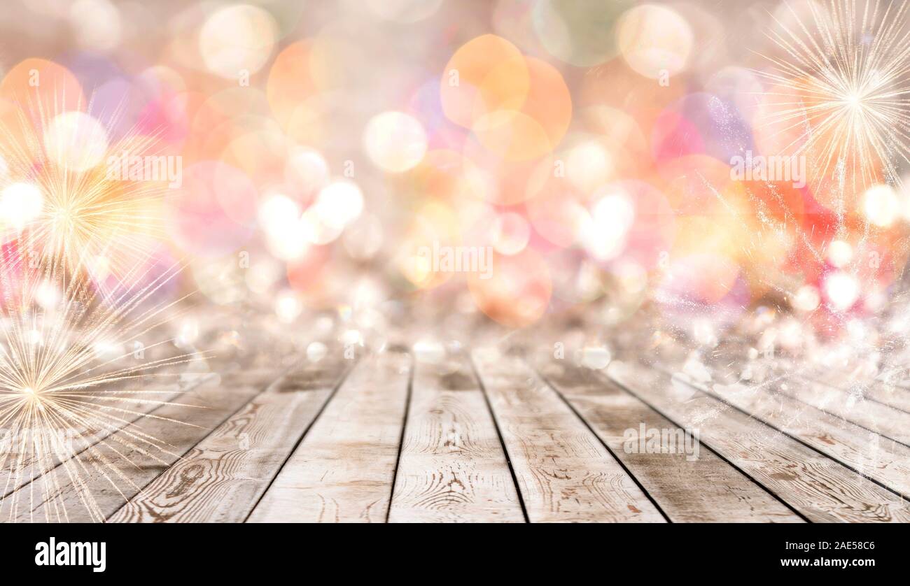 Holiday glitter light background with firework and wood copy space ...