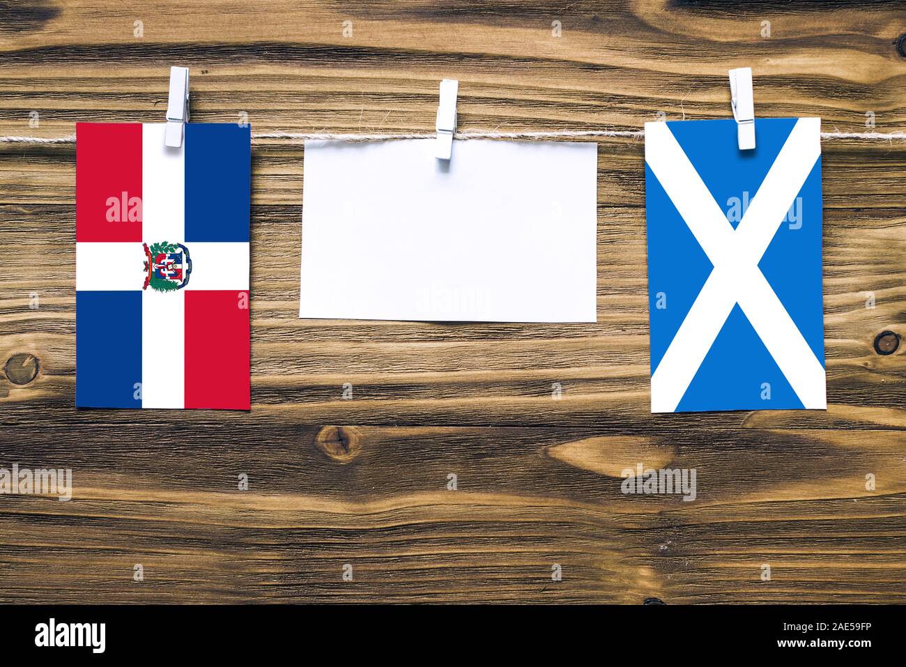 Hanging flags of Dominican Republic and Scotland attached to rope with ...