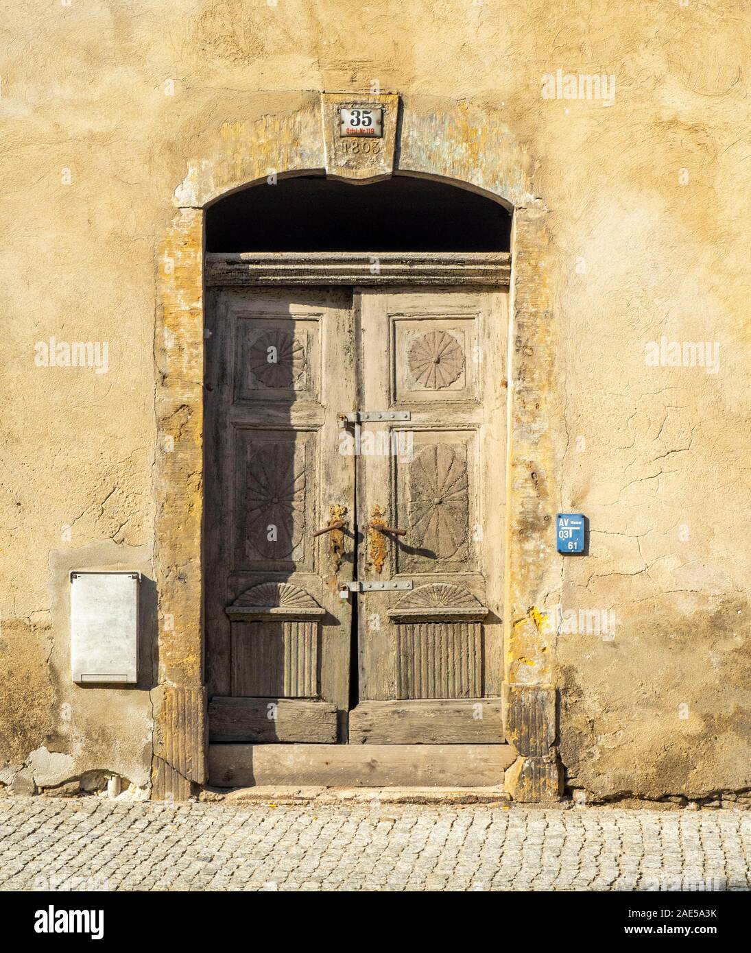 Rustic wooden door and weathered wall Stock Photo - Alamy