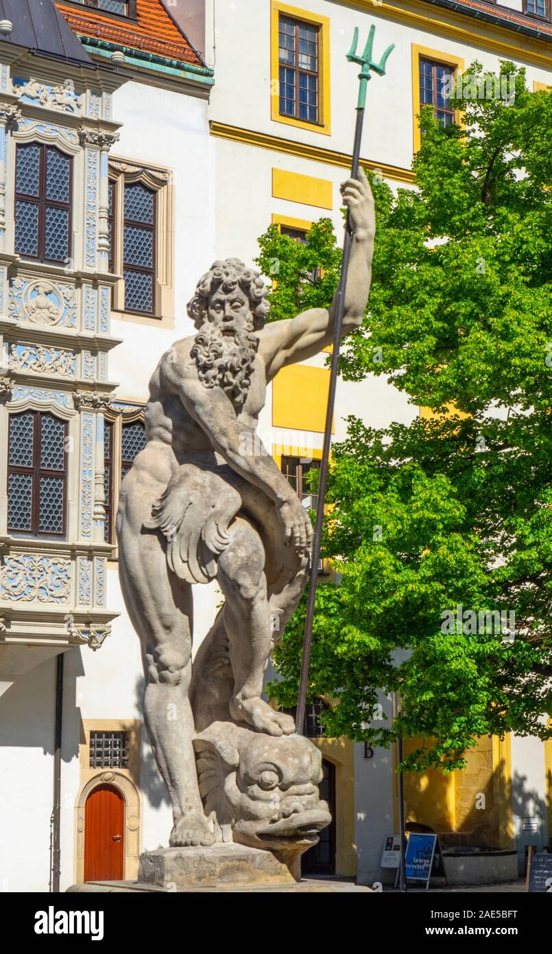 Stone statue of Neptune in fountain and Schöner Erkerin oriel bay ...