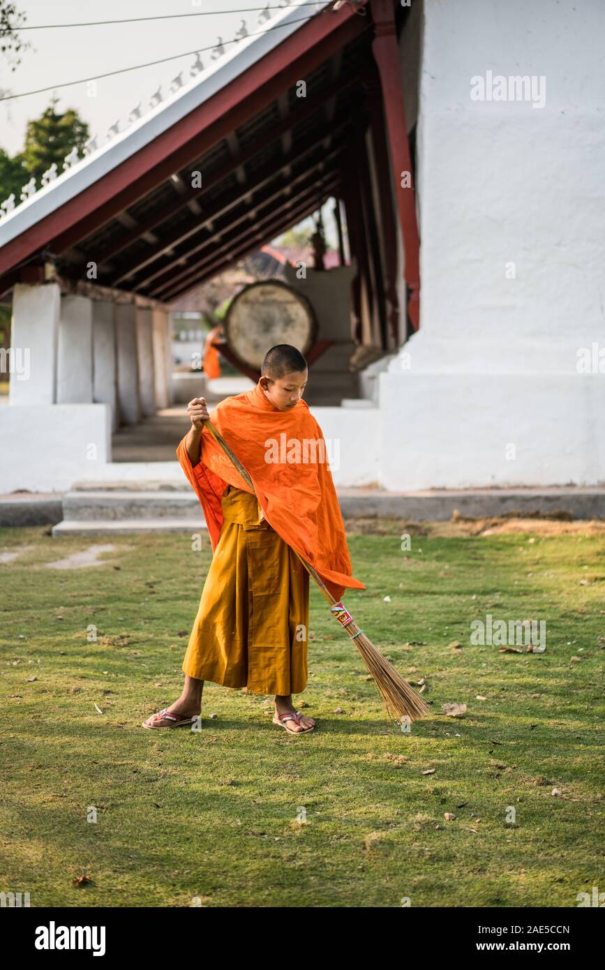 Monk cleaning street in the Luang Prabang, Laos, Asia Stock Photo - Alamy