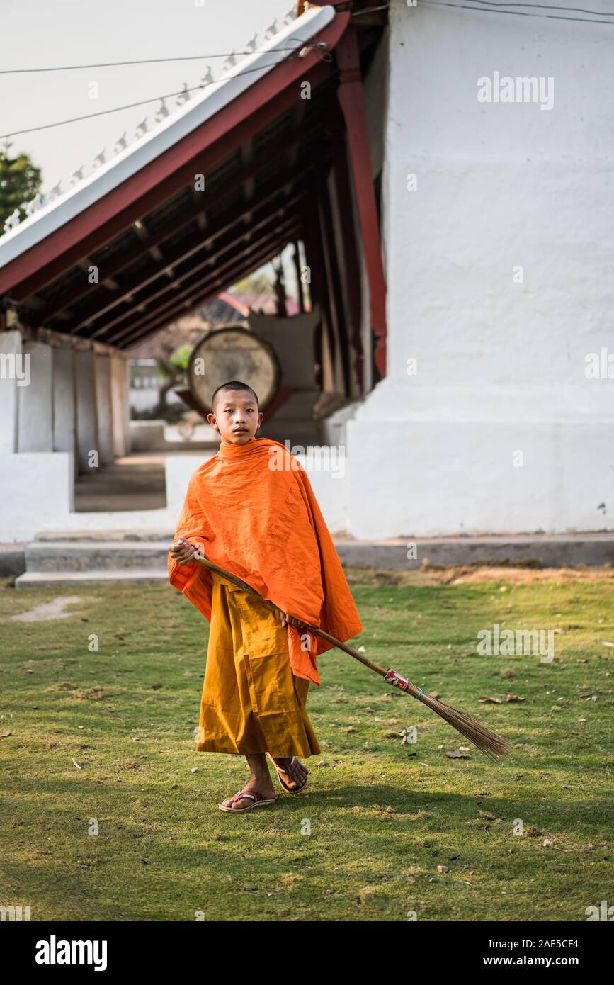 Monk cleaning street in the Luang Prabang, Laos, Asia Stock Photo - Alamy