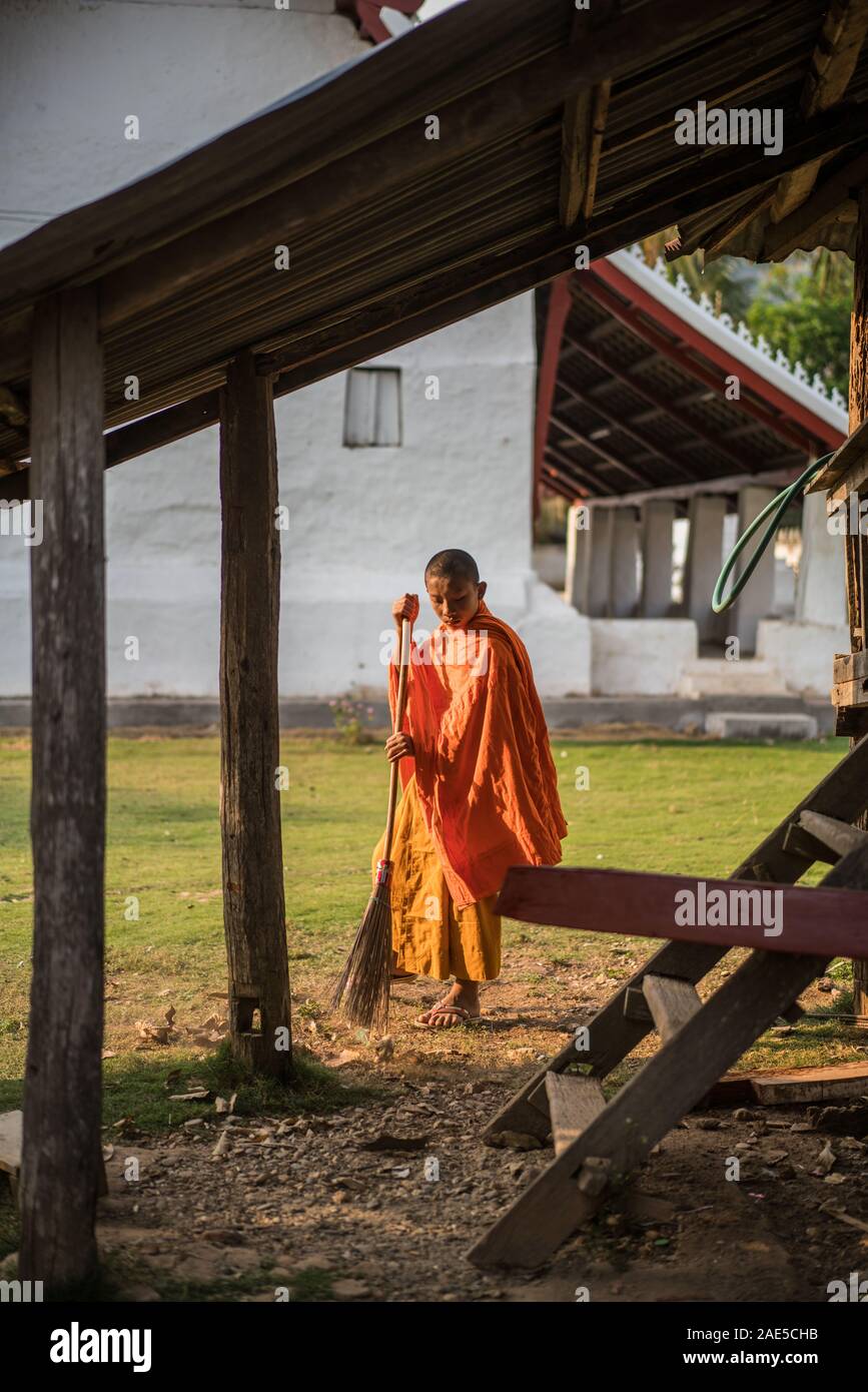 Monk cleaning street in the Luang Prabang, Laos, Asia Stock Photo - Alamy