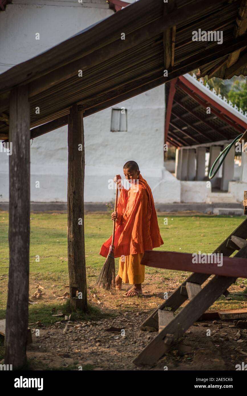 Monk cleaning street in the Luang Prabang, Laos, Asia Stock Photo - Alamy