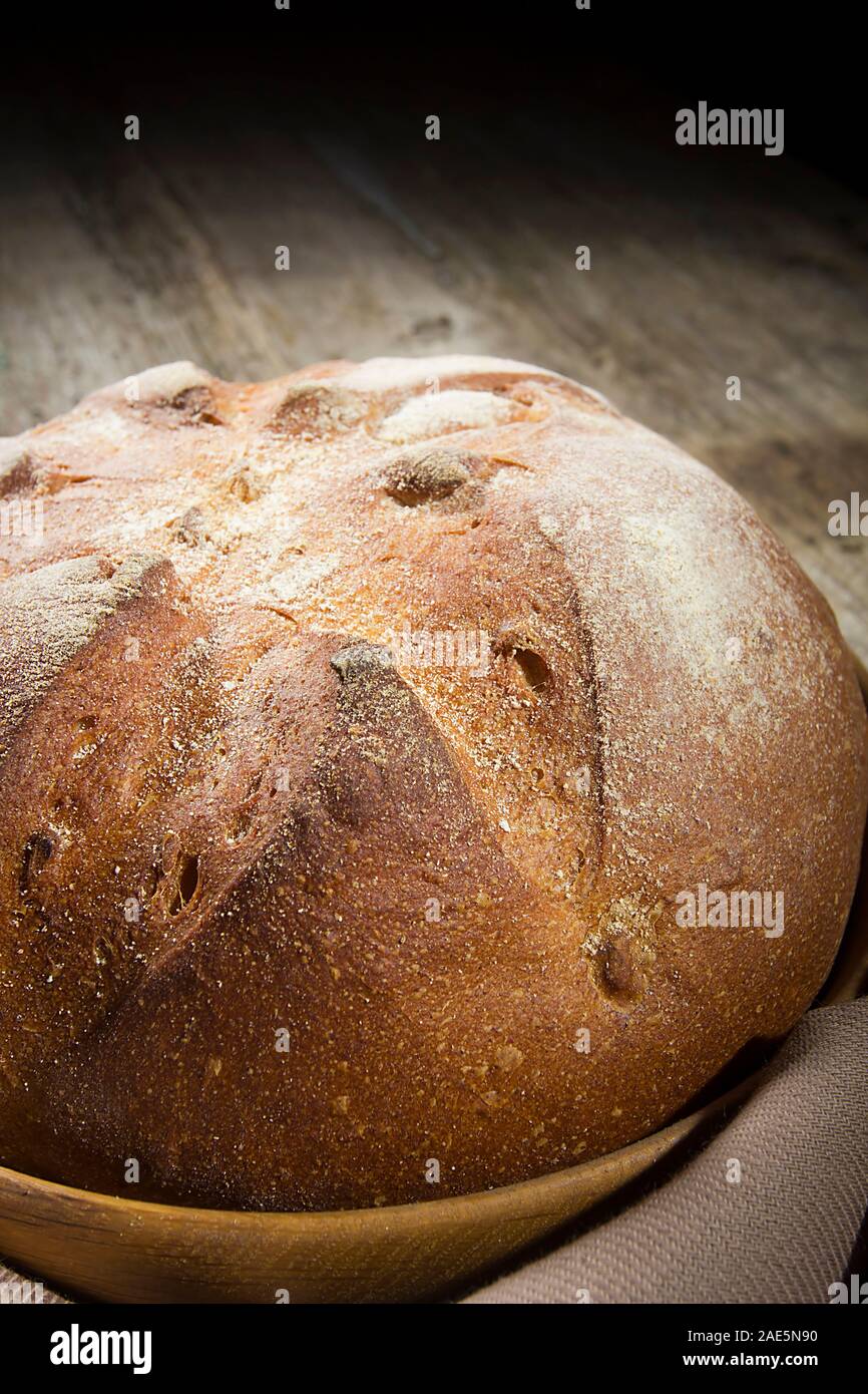 Plate with a loaf of bread on a table of old wood Stock Photo - Alamy