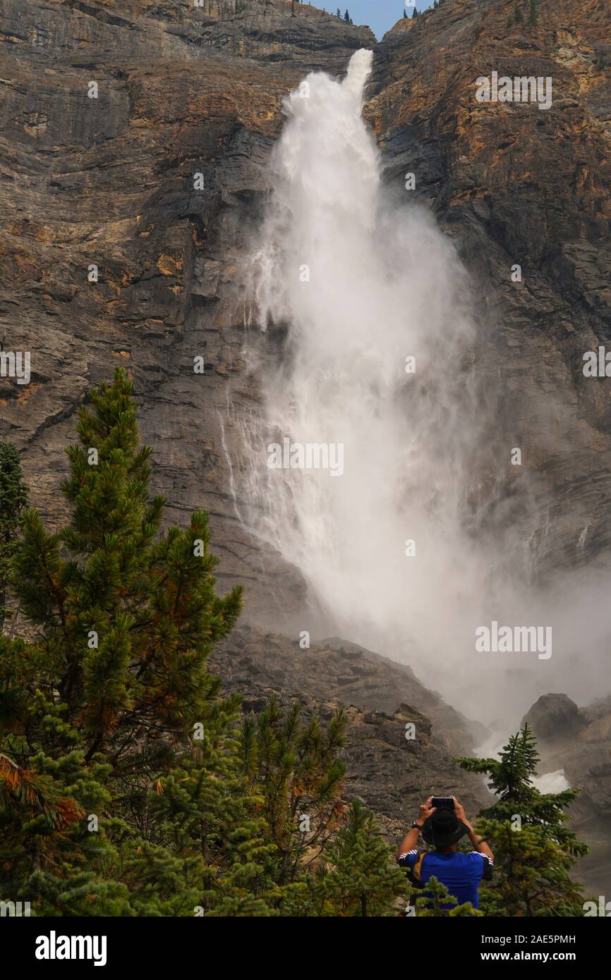A visitor capturing the size and power of Takakkaw Falls in Yoho ...