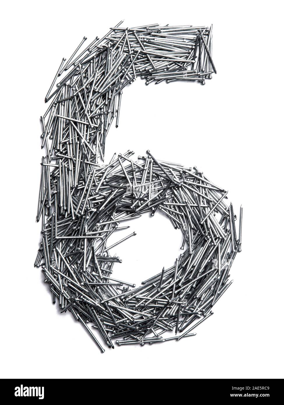 Arabic numeral "6" from small iron nails on a white isolated background ...