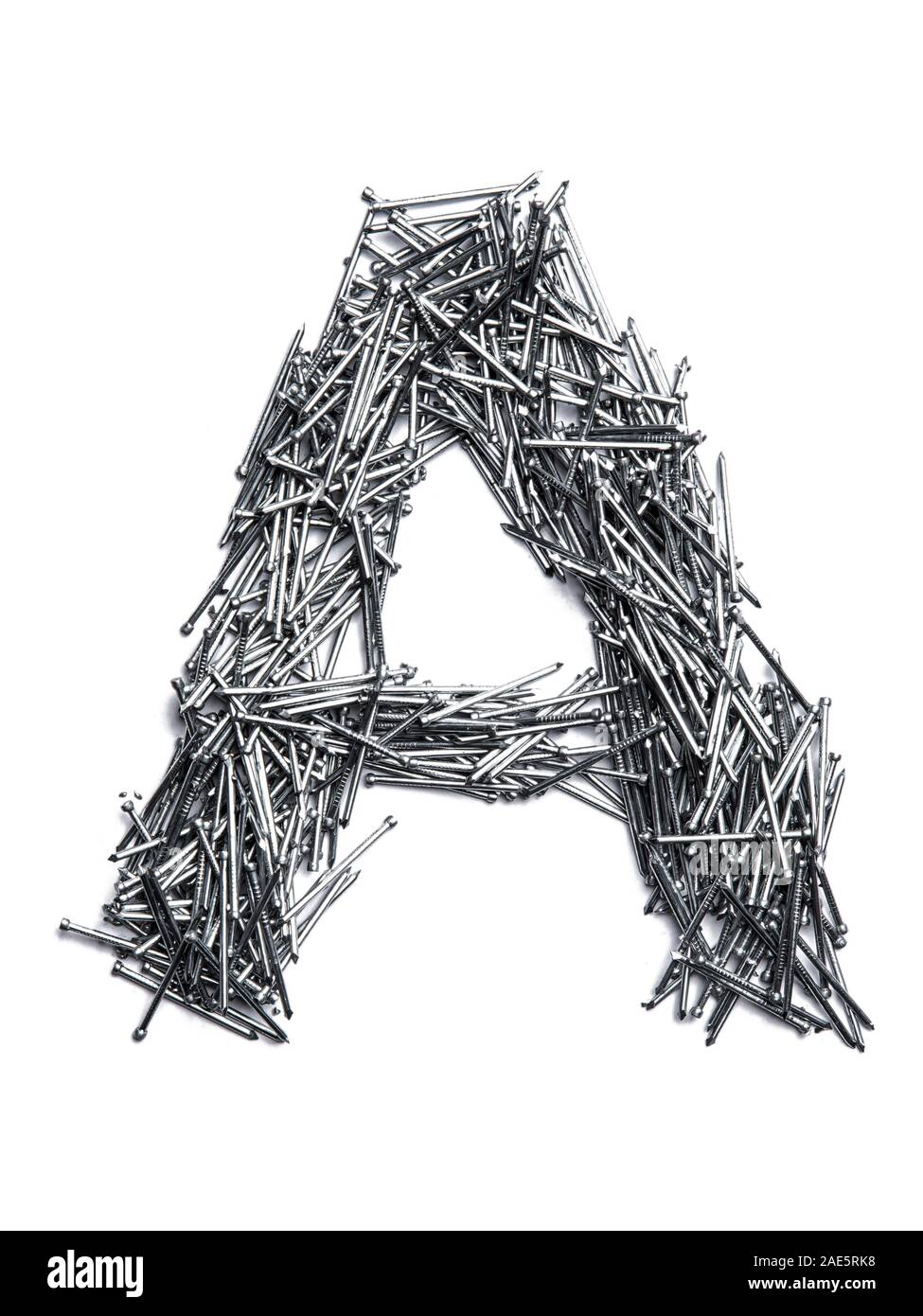 Letter A of the English alphabet from small iron nails on a white ...