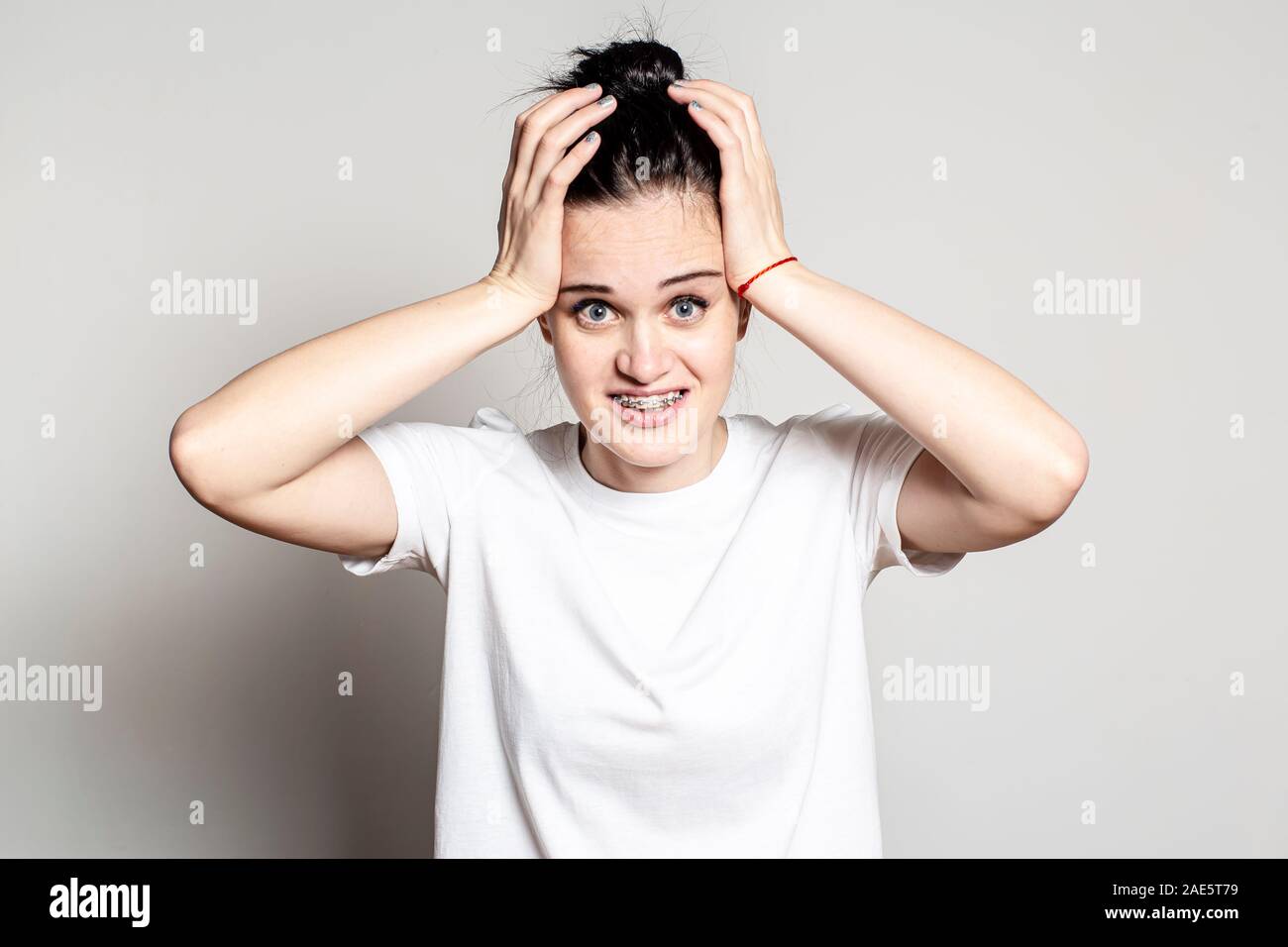 Shocked by an unexpected surprise, the woman smiles strangely and ...