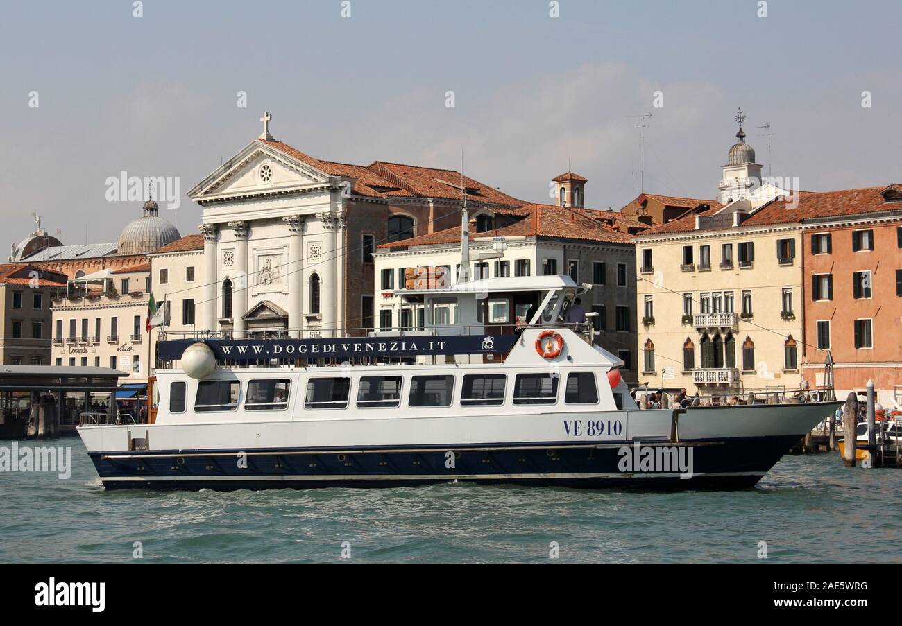 Tourist charter boat at the waterfront with the Church of the Pieta ...