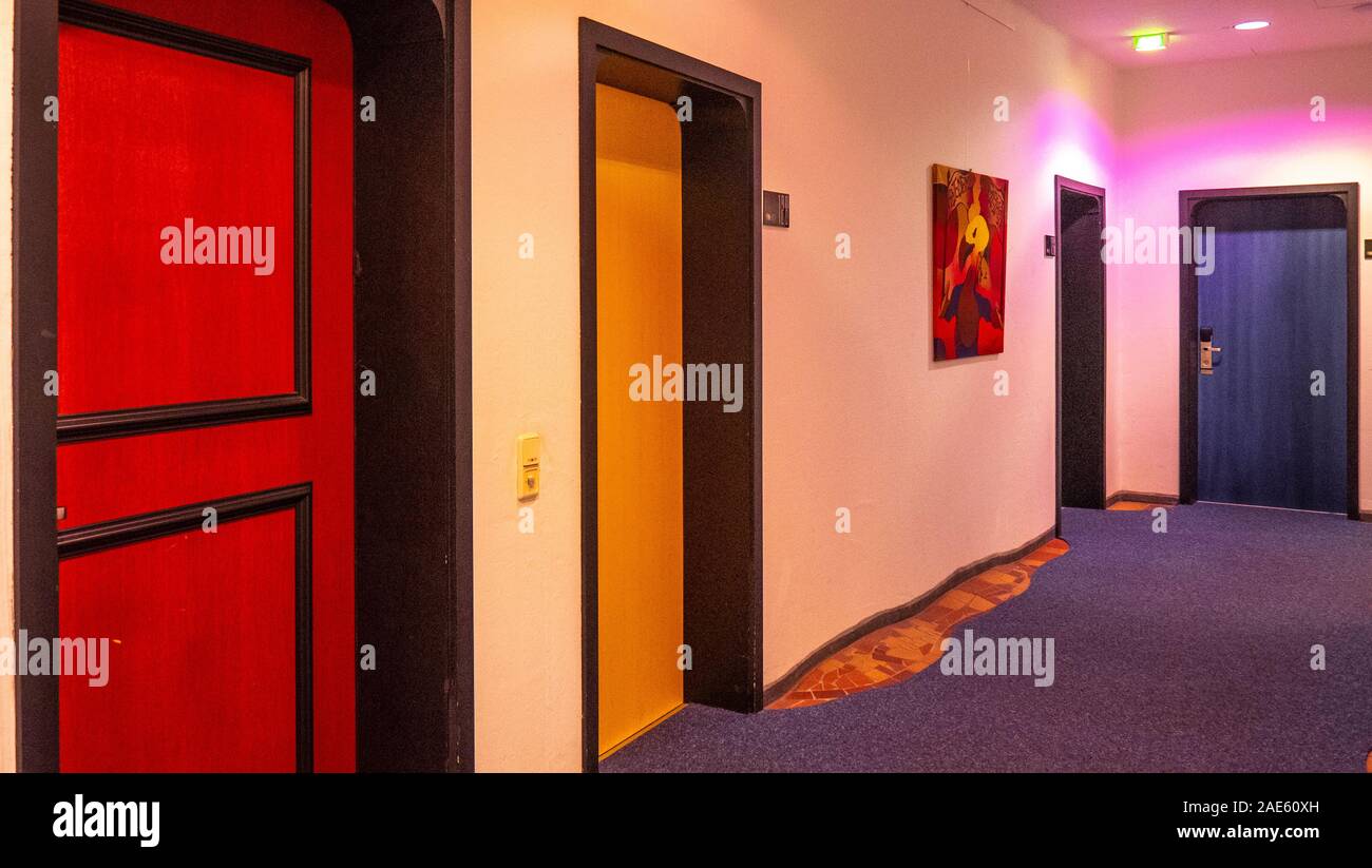 Coloured doors and corridor inside the artHOTEL in Hundertwasser Green ...