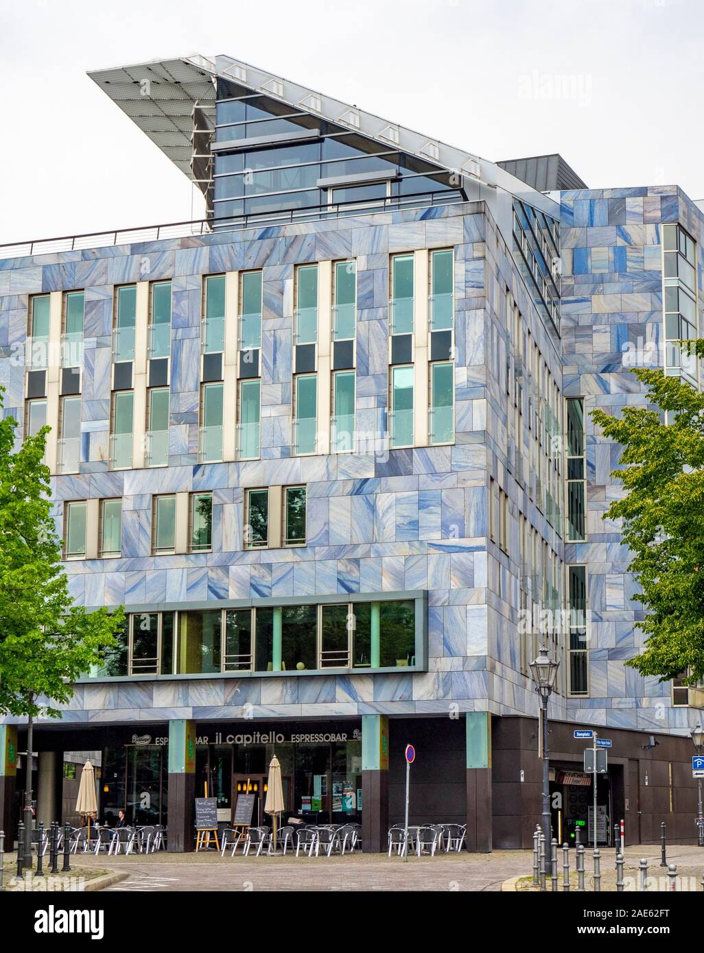 Blue granite cladding on a modern office building and outdoor dining ...