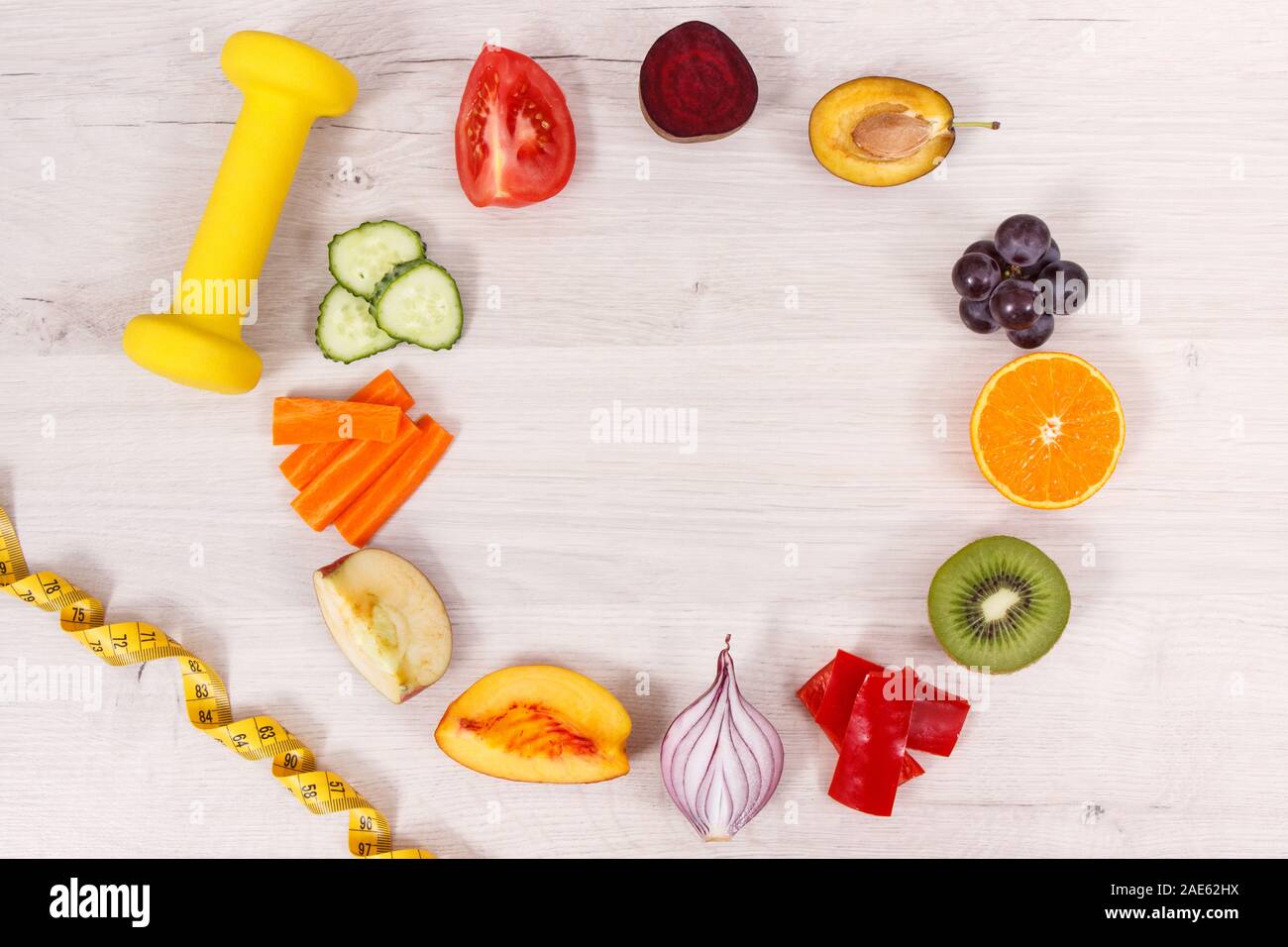 Natural fruits and vegetables, dumbbell for fitness with tape measure ...