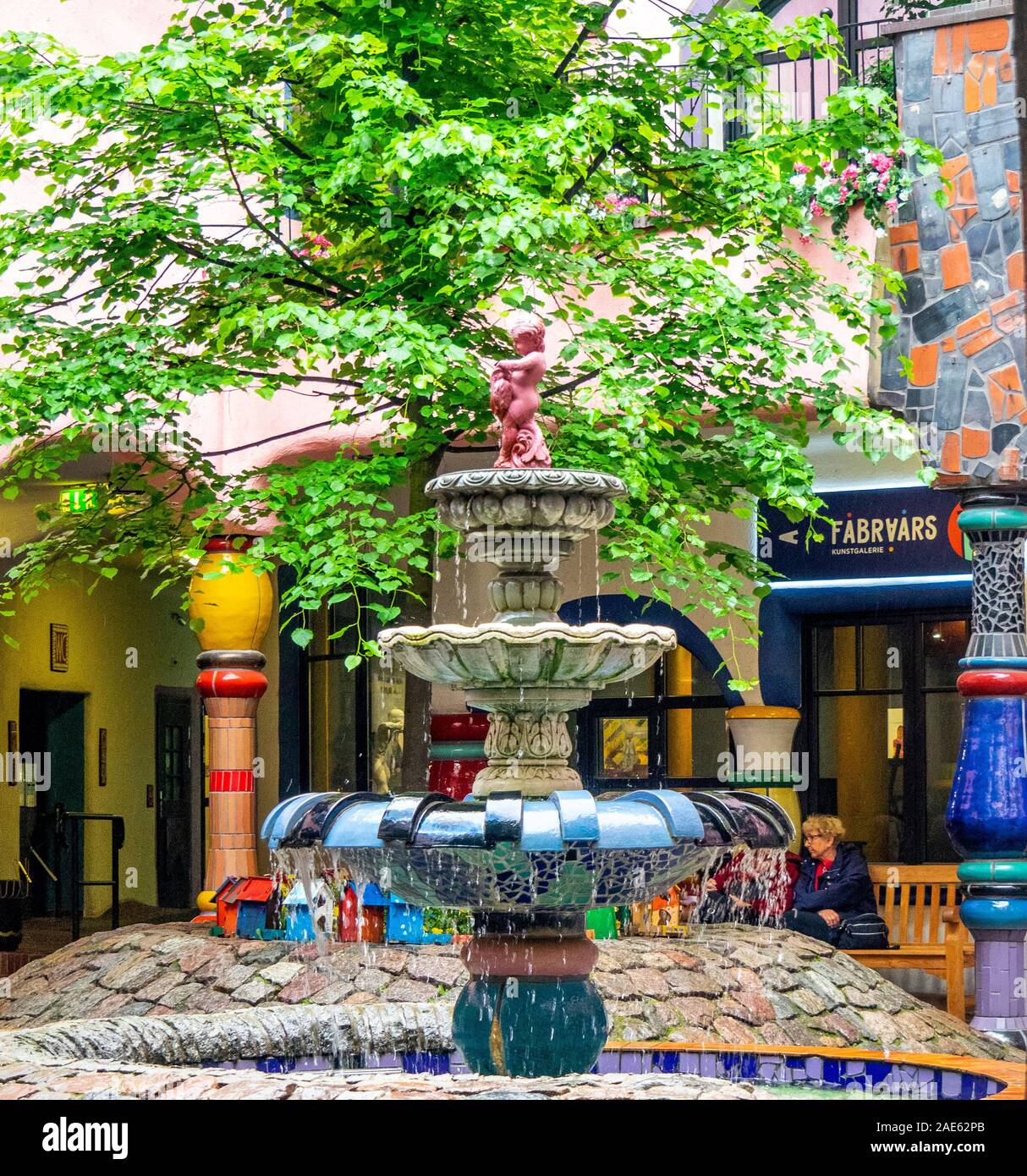 Colourful ceramic tiled columns and fountain in a courtyard of ...