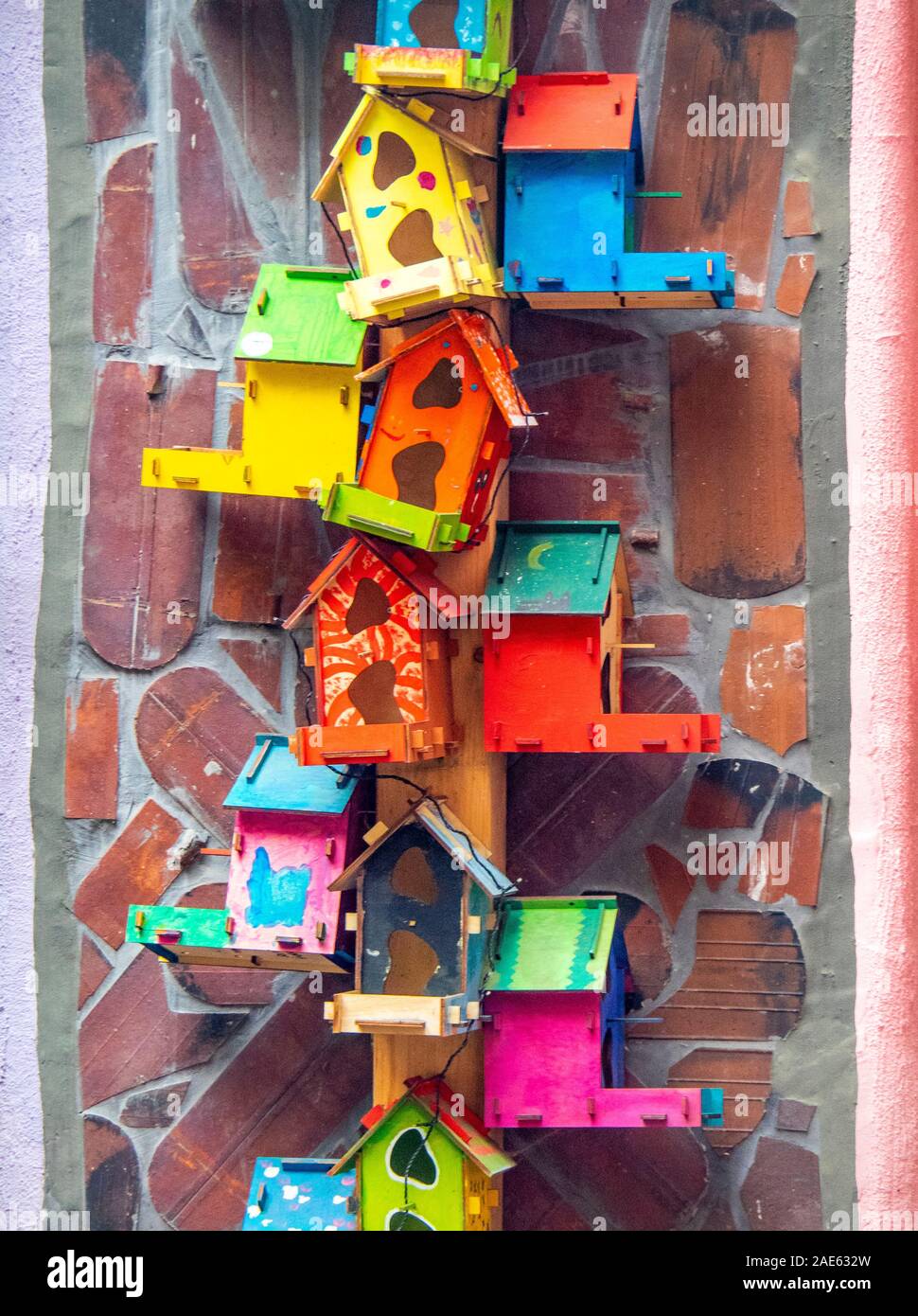 Colourful birdhouses attached to a wall in a courtyard of Hundertwasser ...