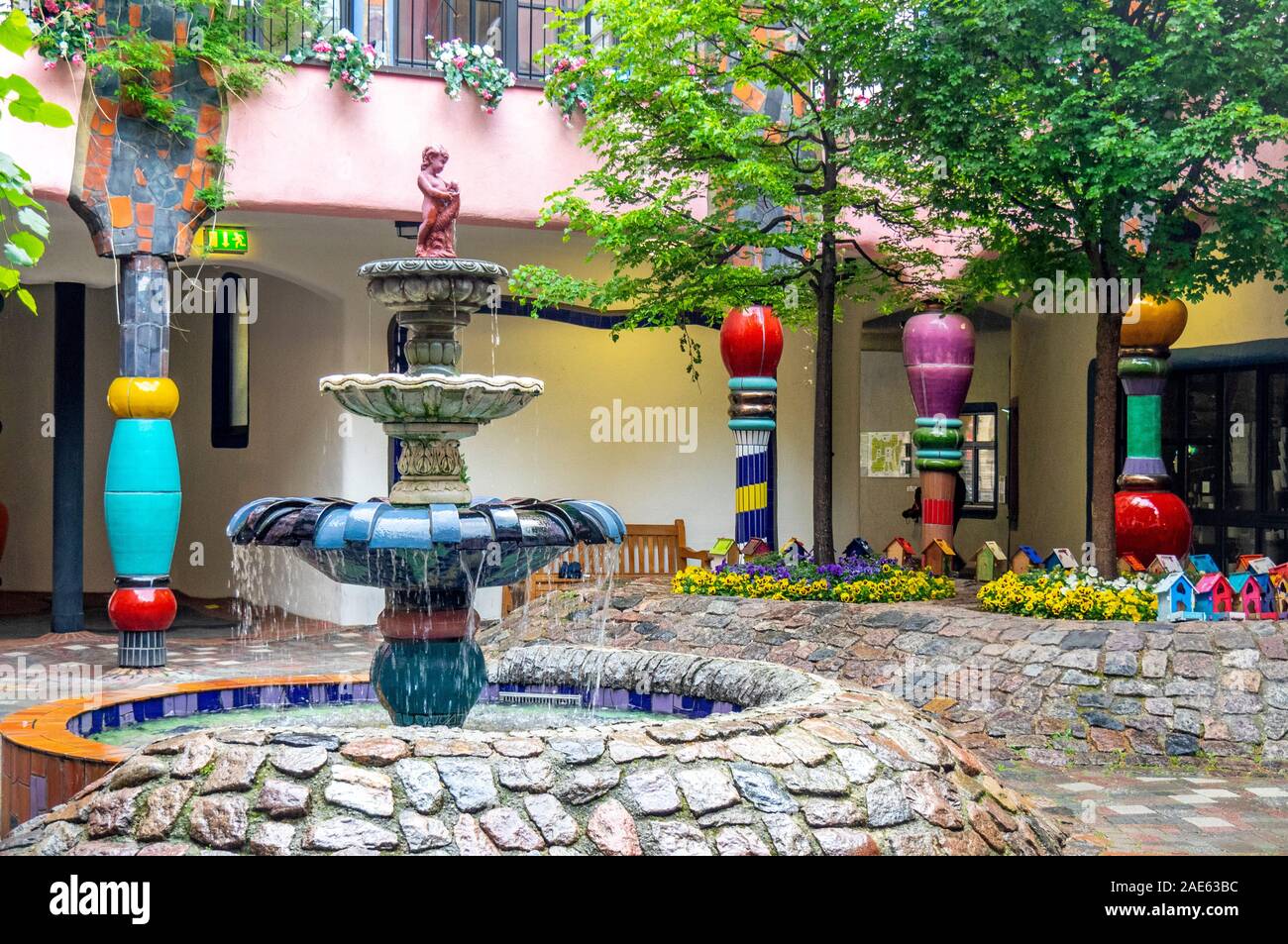 Colourful ceramic tiled columns and fountain in a courtyard of ...