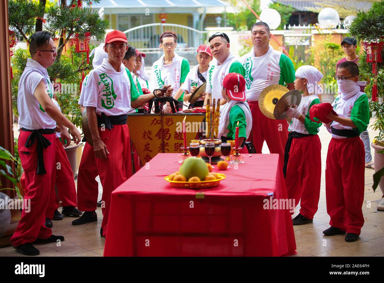 Lion dance teammate operating the musical instruments such as gong ...