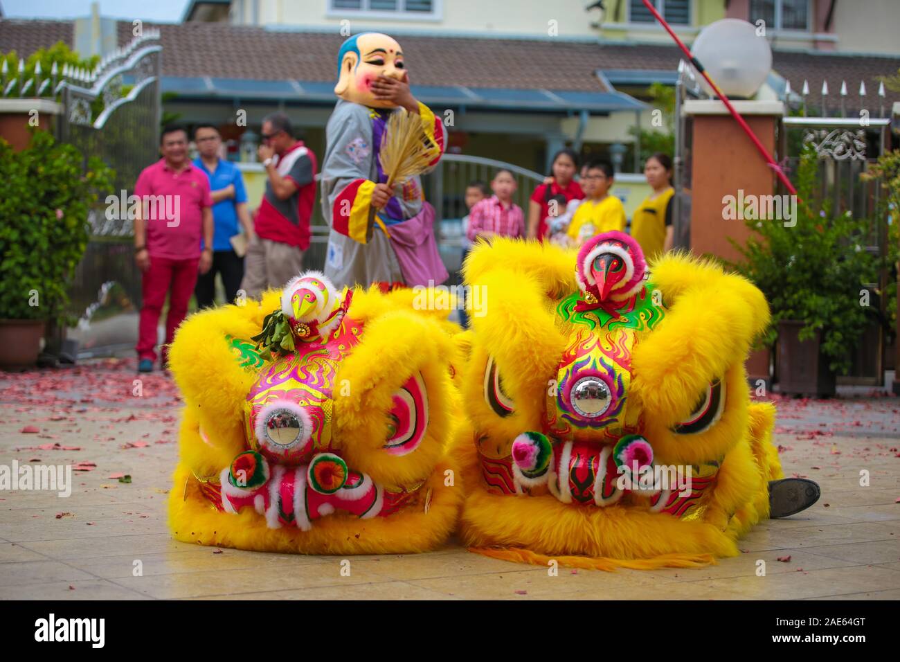 2 lion and a big head buddha at a lion dance show during chinese new ...