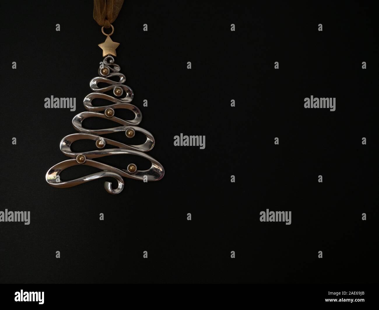 Stylized silver-toned metal Christmas tree with gold-toned ornaments ...
