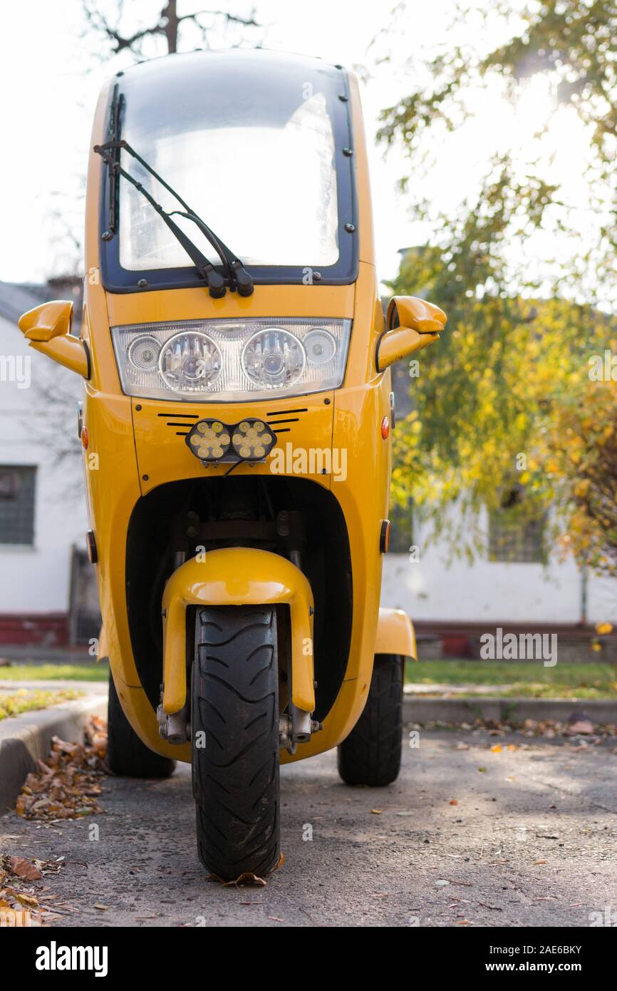 Front view of yellow three wheeled cabin motorcycle, headlight Stock ...