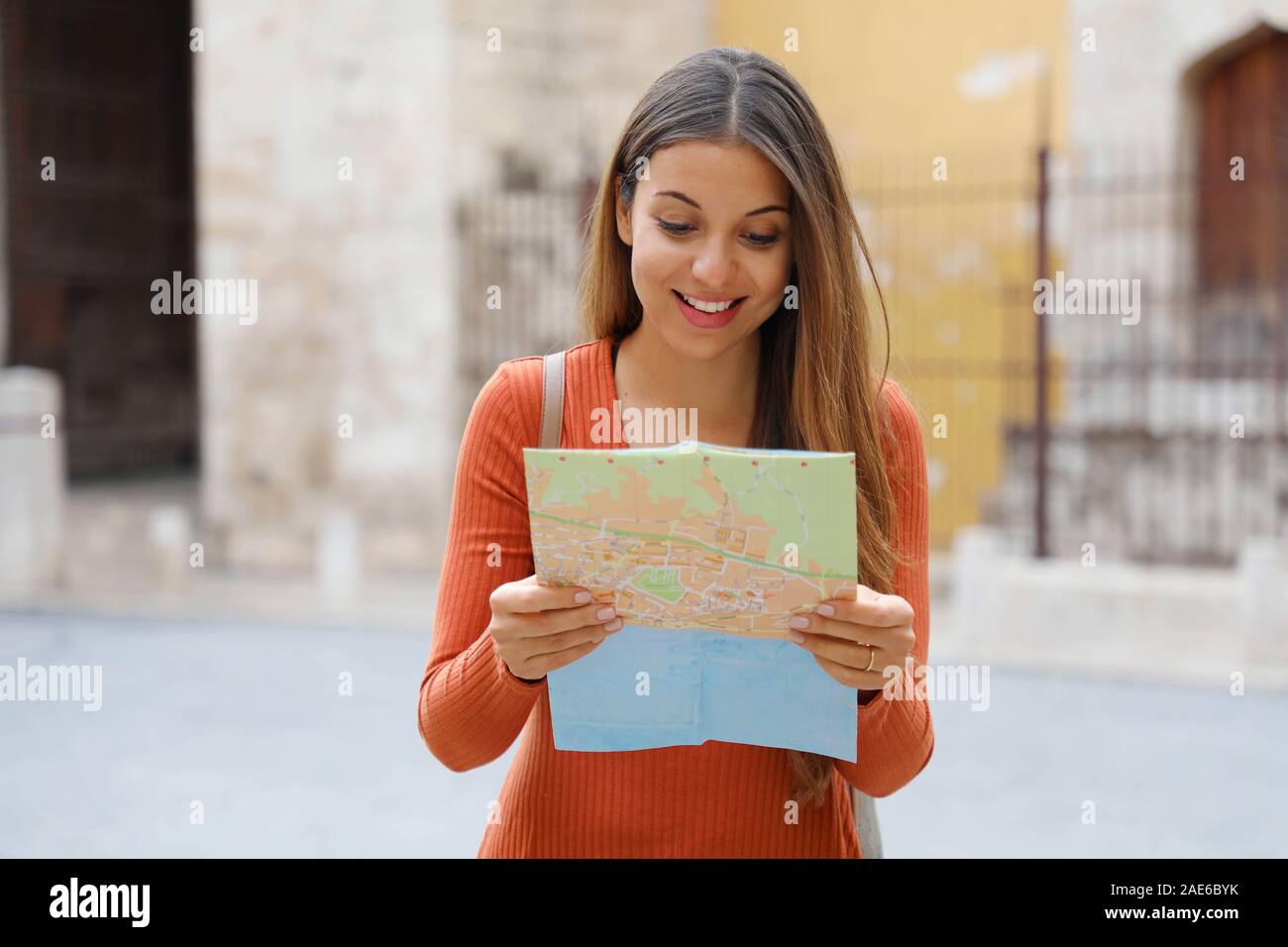 Young woman searching direction on city map. Happy cheerful female ...