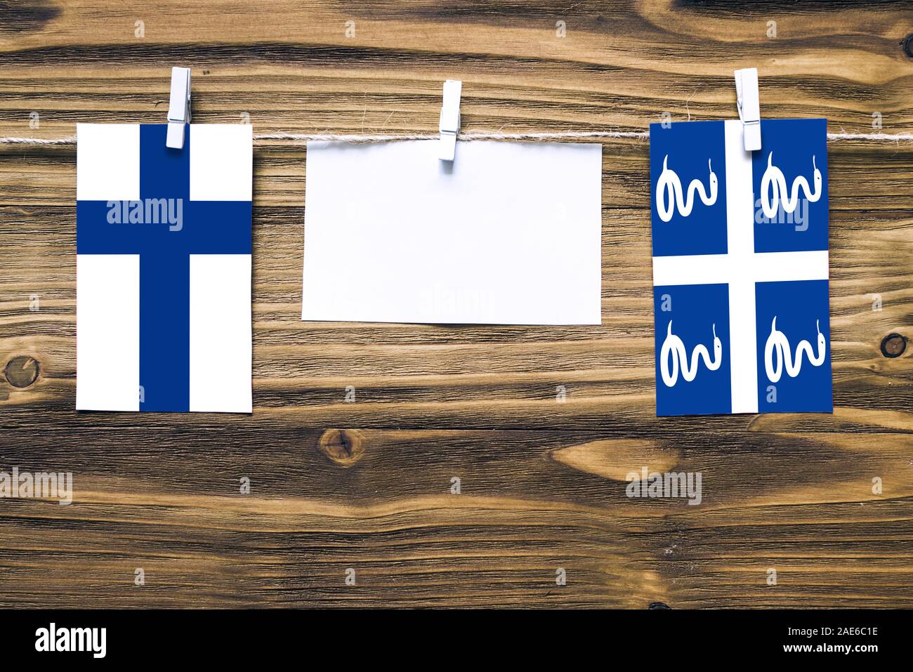 Hanging flags of Finland and Martinique attached to rope with clothes ...