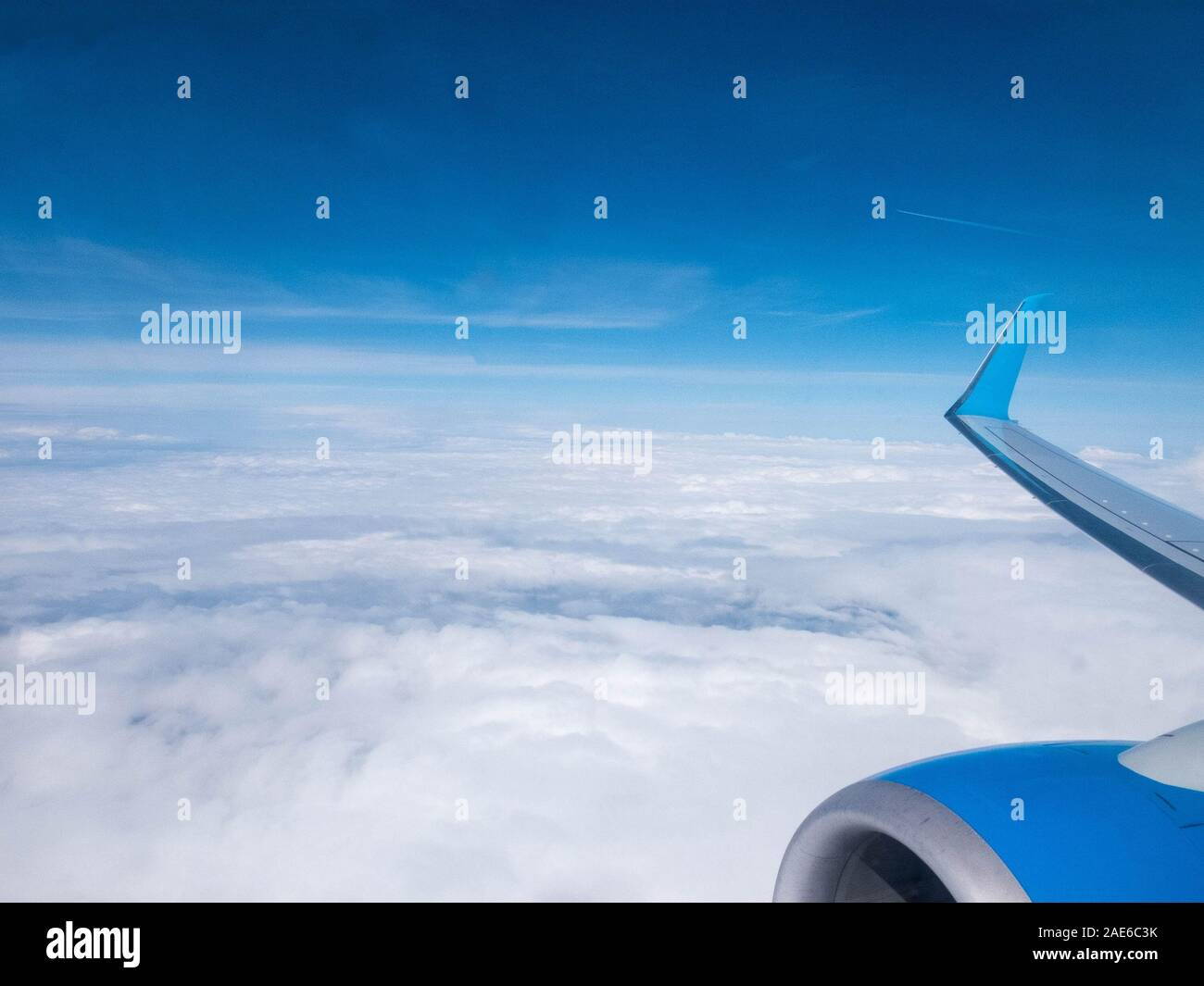 Clouds,clear bright blue sky, engine and wing of plane. Aerial view ...