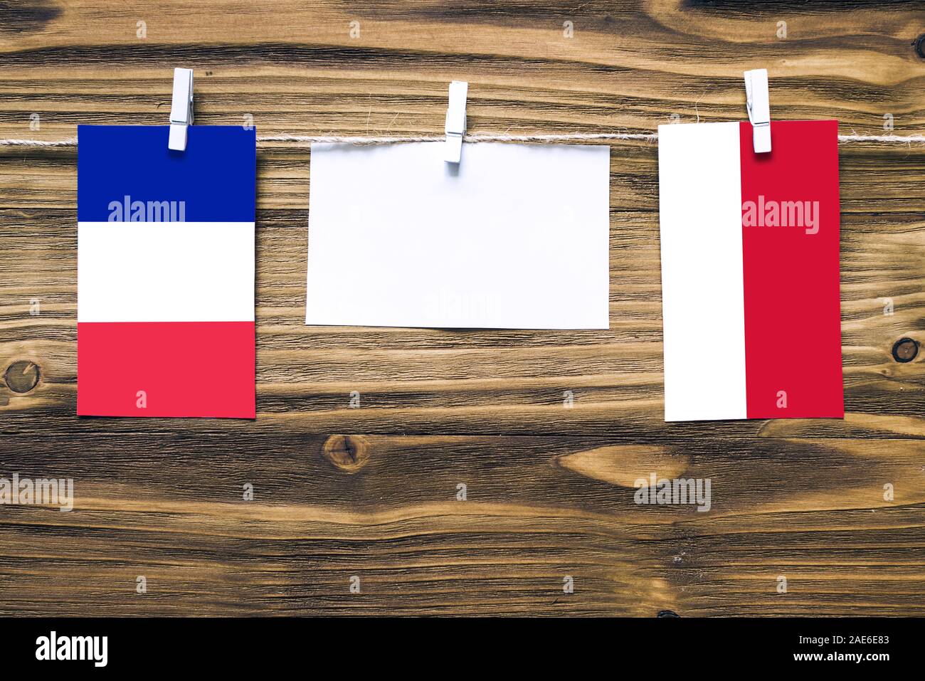 Hanging flags of France and Monaco attached to rope with clothes pins ...