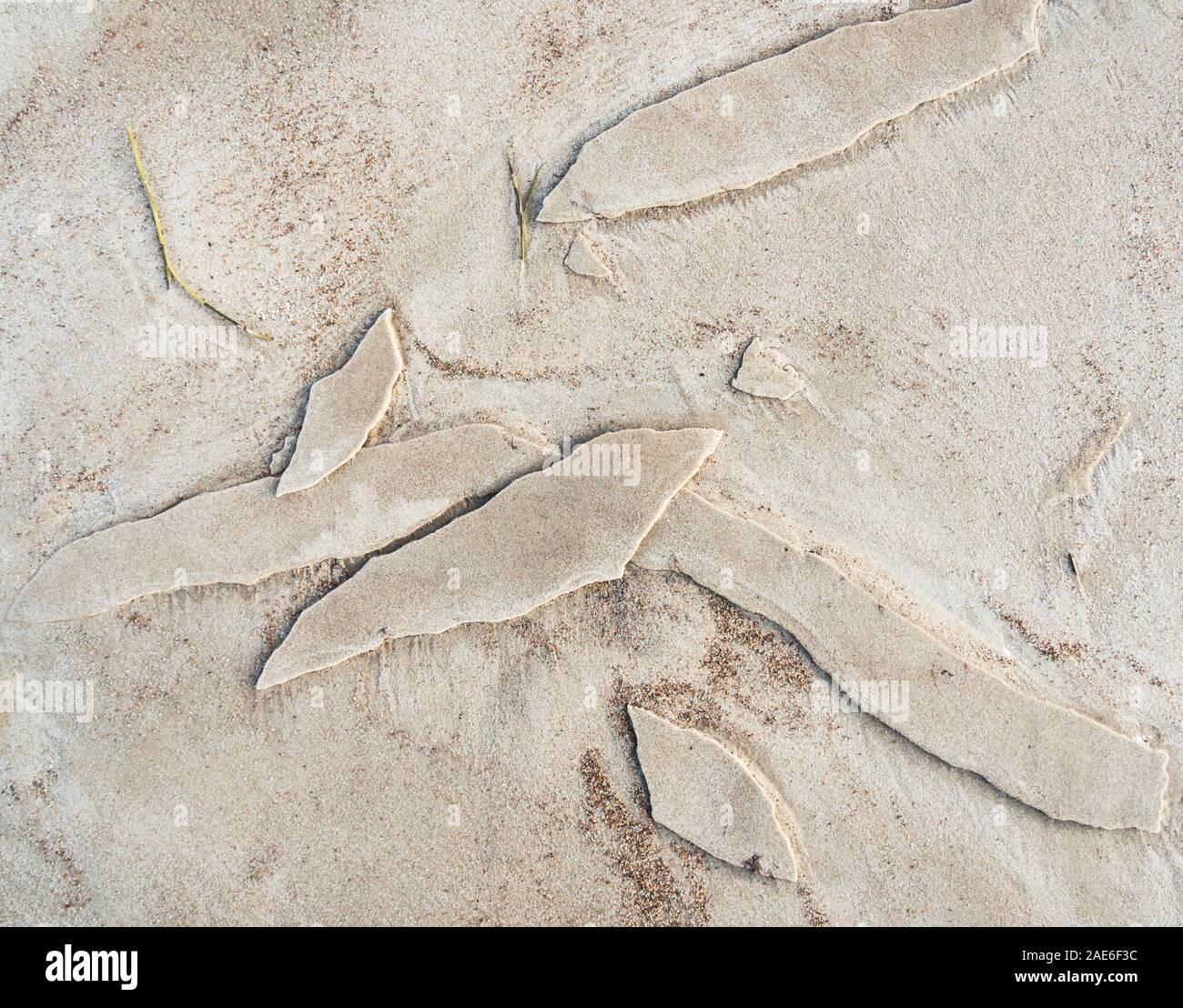 Beach background with broken frosted piece of wet sand Stock Photo - Alamy