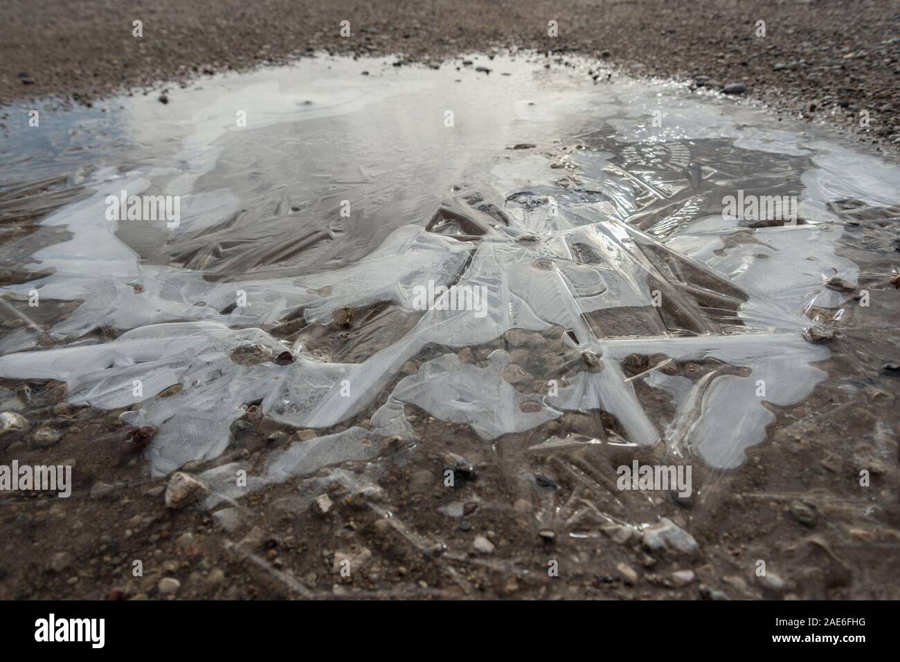 Puddle on the road in cool day Stock Photo - Alamy