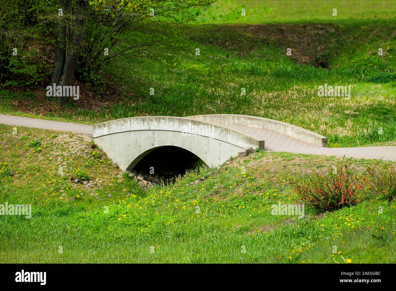 Small new stone bridge over ditch Stock Photo - Alamy
