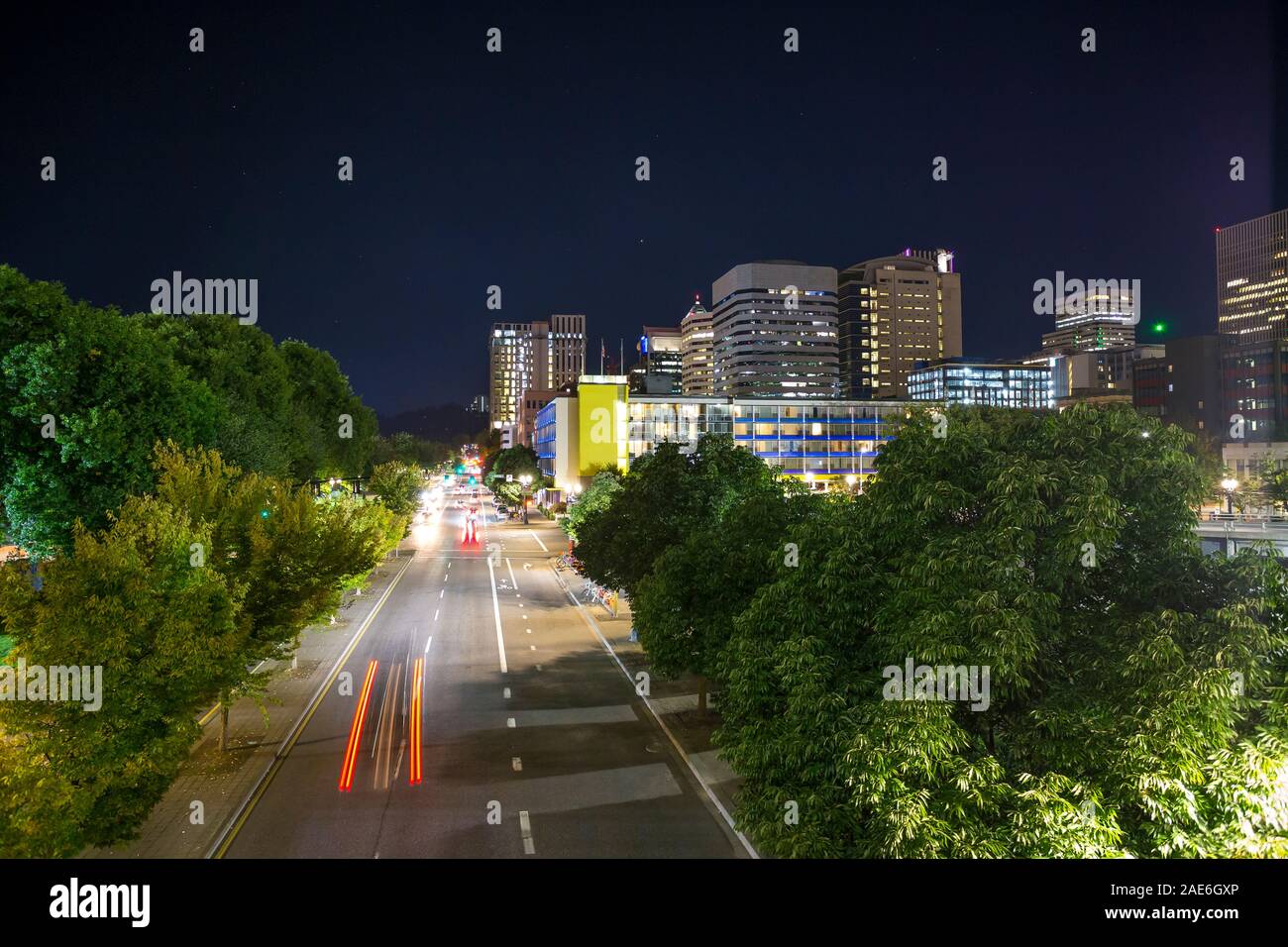 Pacific Highway in downtown Portland Oregon at night as cars drive fast ...