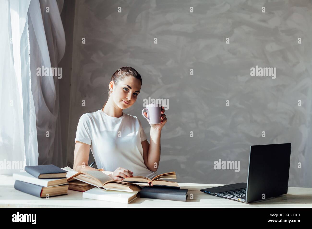 girl reading a book and drinking coffee Stock Photo - Alamy