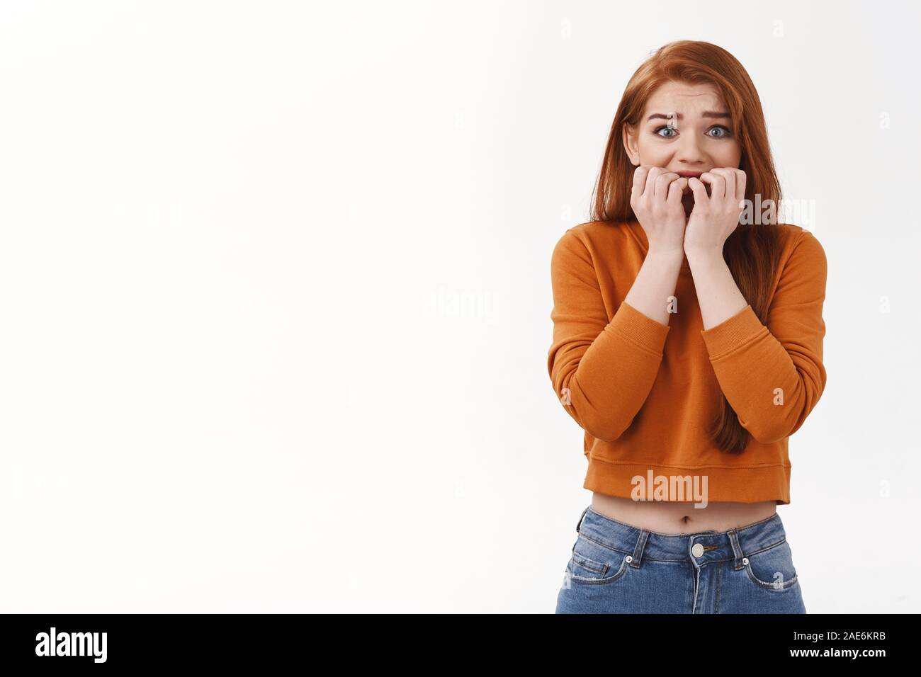 Scared timid cute redhead woman watching horror movie, trembling from ...