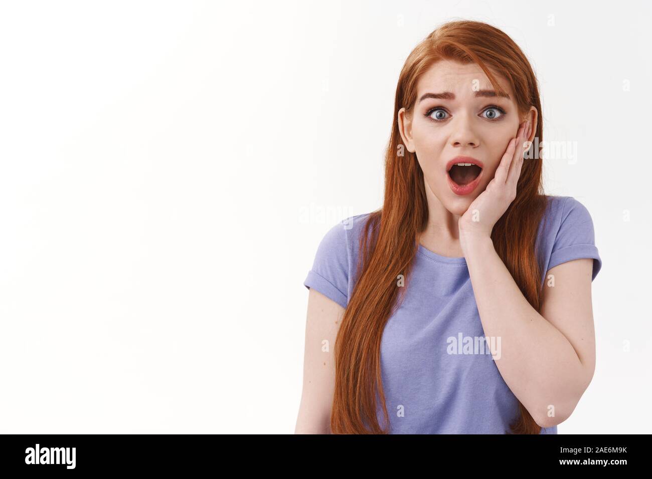 Shocked, concerned young redhead girl express compassion and worry ...