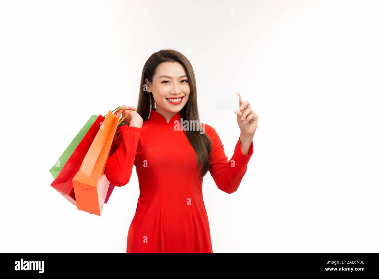 Asian woman in ao dai traditional red dress holding shopping bag and ...