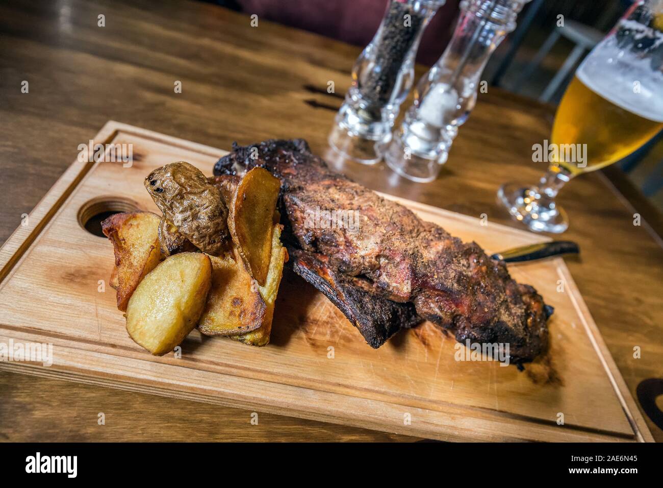 Delicious beef ribs dish at local restaraunt on wooden plate Stock ...