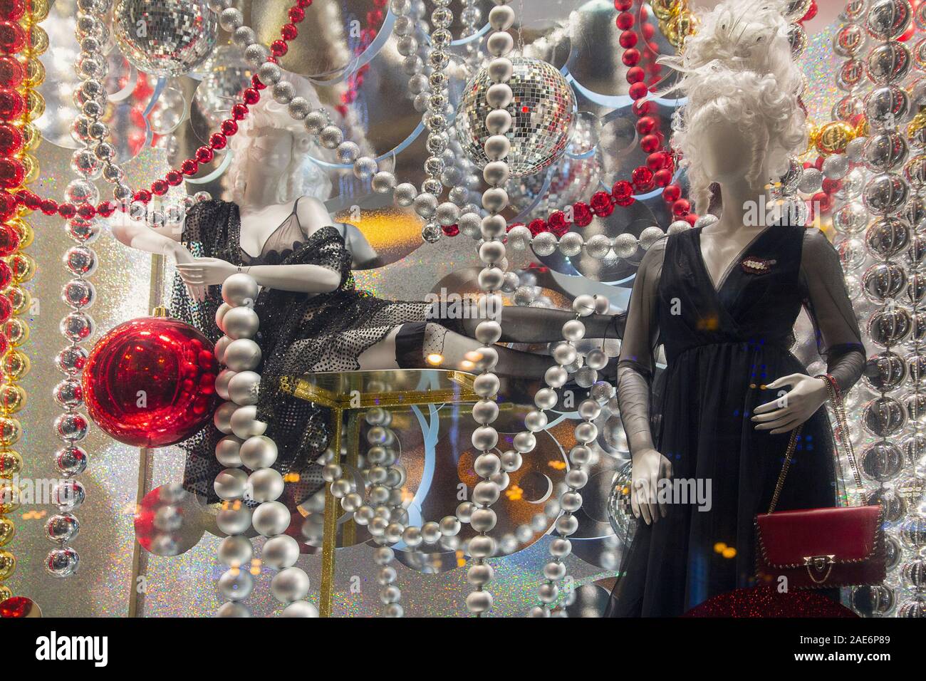 Female mannequin in a luxurious outfit in the shop window. Fashion ...