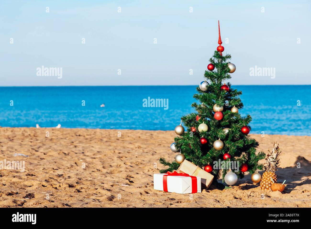 Christmas on the beach with gifts new year Stock Photo - Alamy