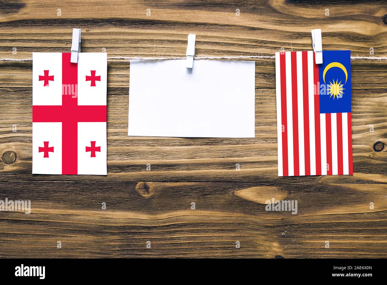 Hanging flags of Georgia and Malaysia attached to rope with clothes ...