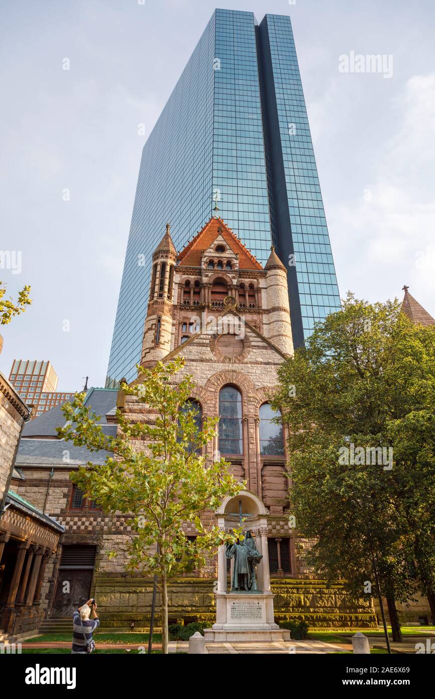 The tall modern skyscraper John Hancock Tower behind historic Trinity ...