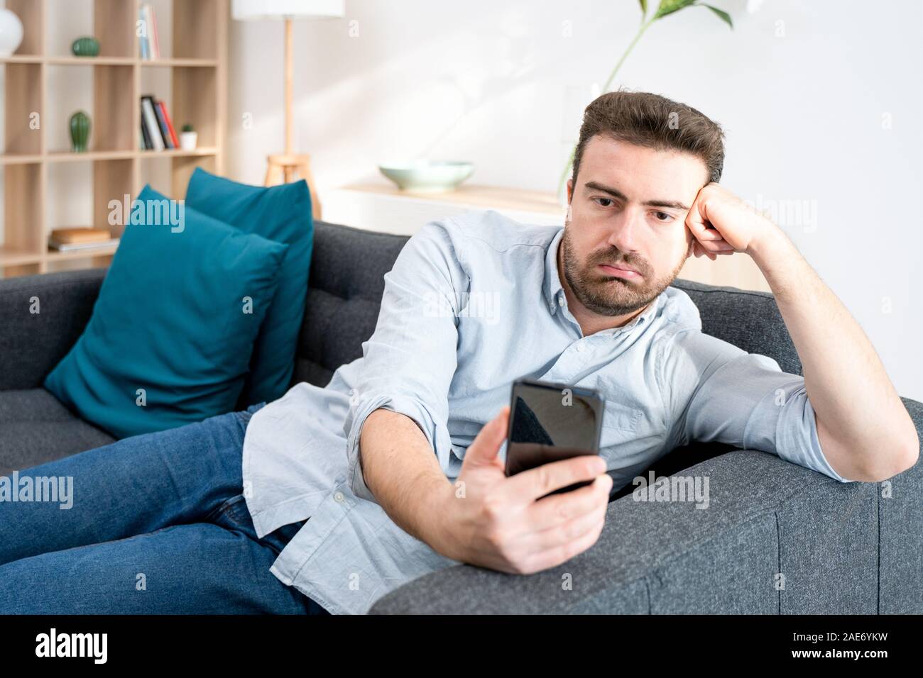 Man reading text message sad hi-res stock photography and images - Alamy